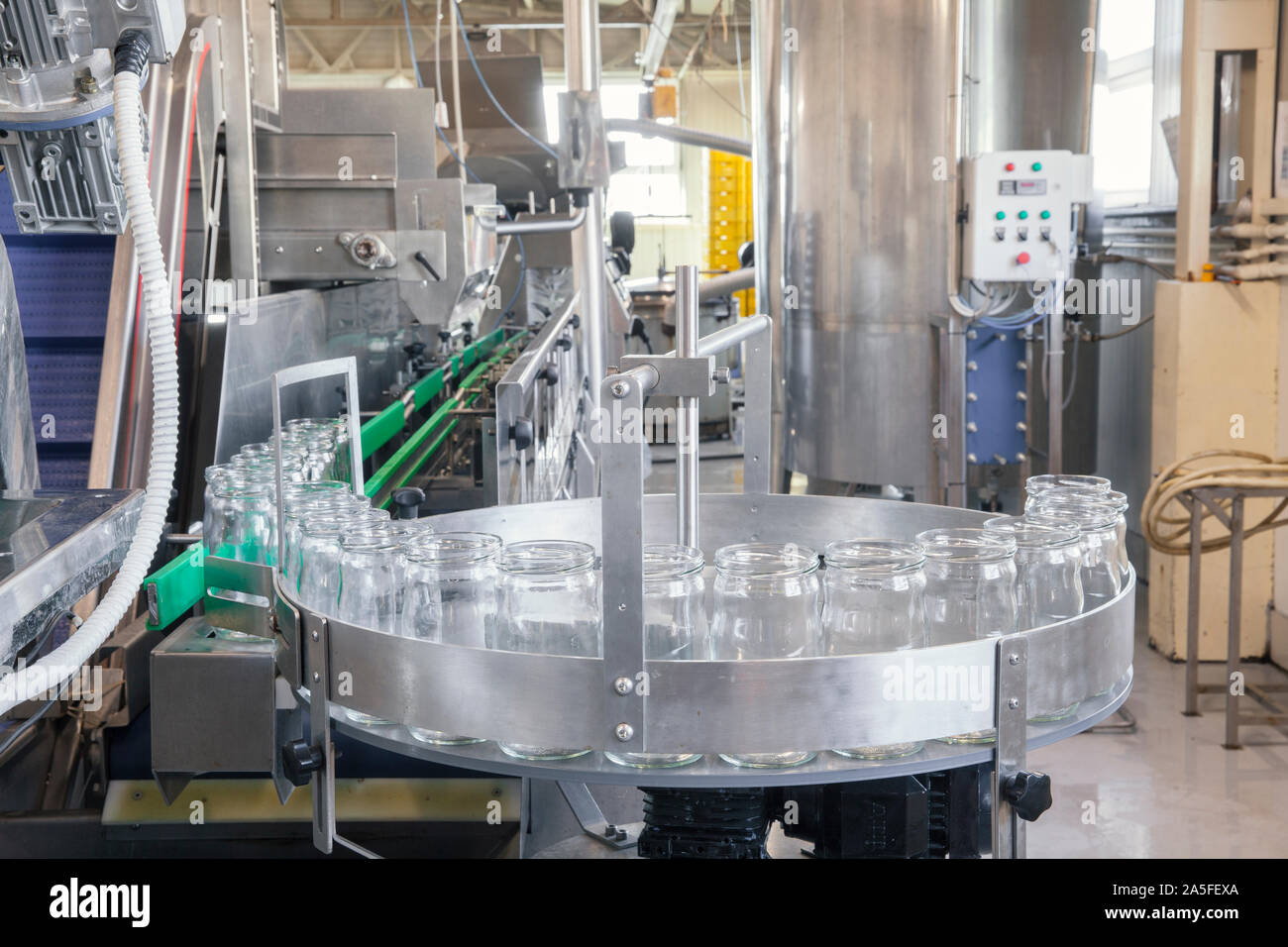 glass jars on the filling line in factory Stock Photo - Alamy