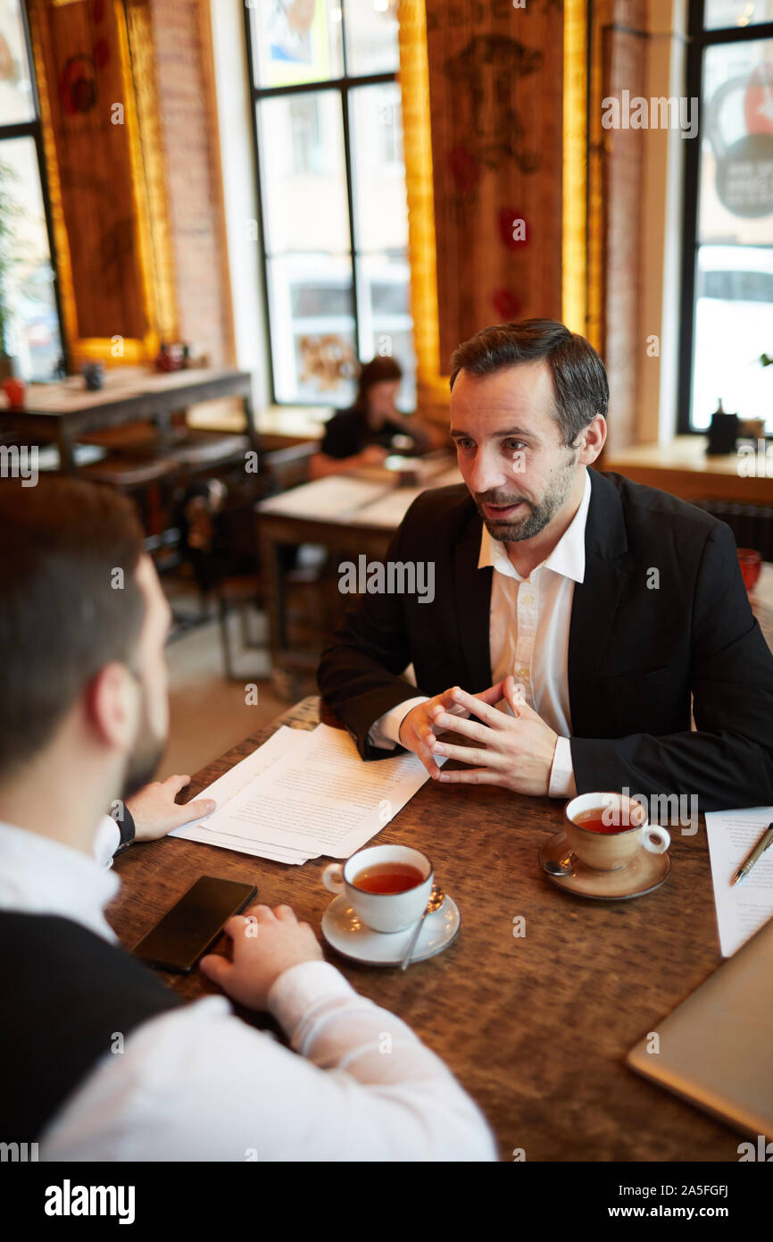 Two men sitting at table at bar High Resolution Stock Photography and ...