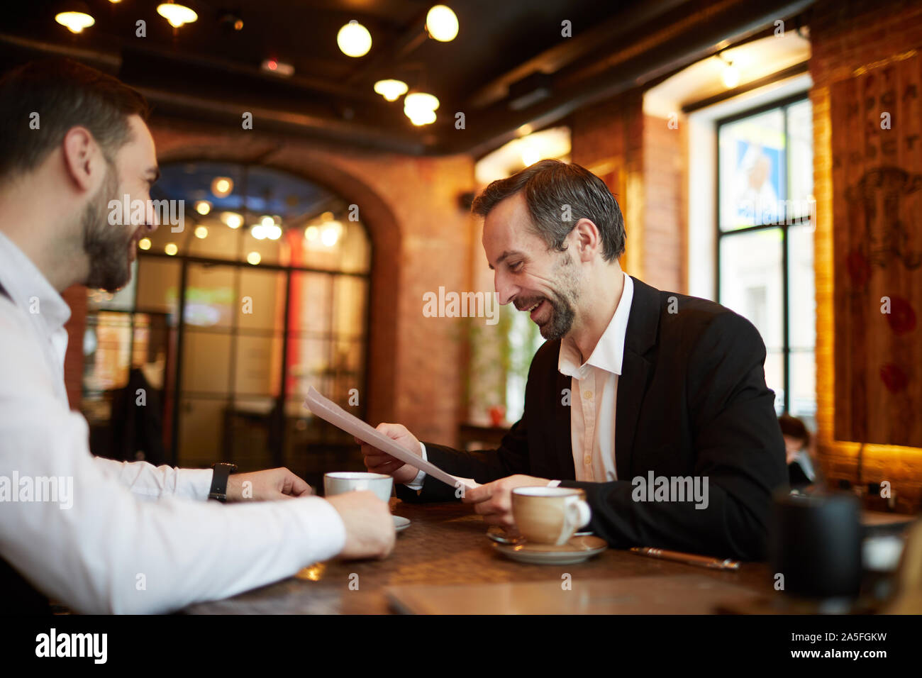 Side view portrait of two successful business people signing contract ...