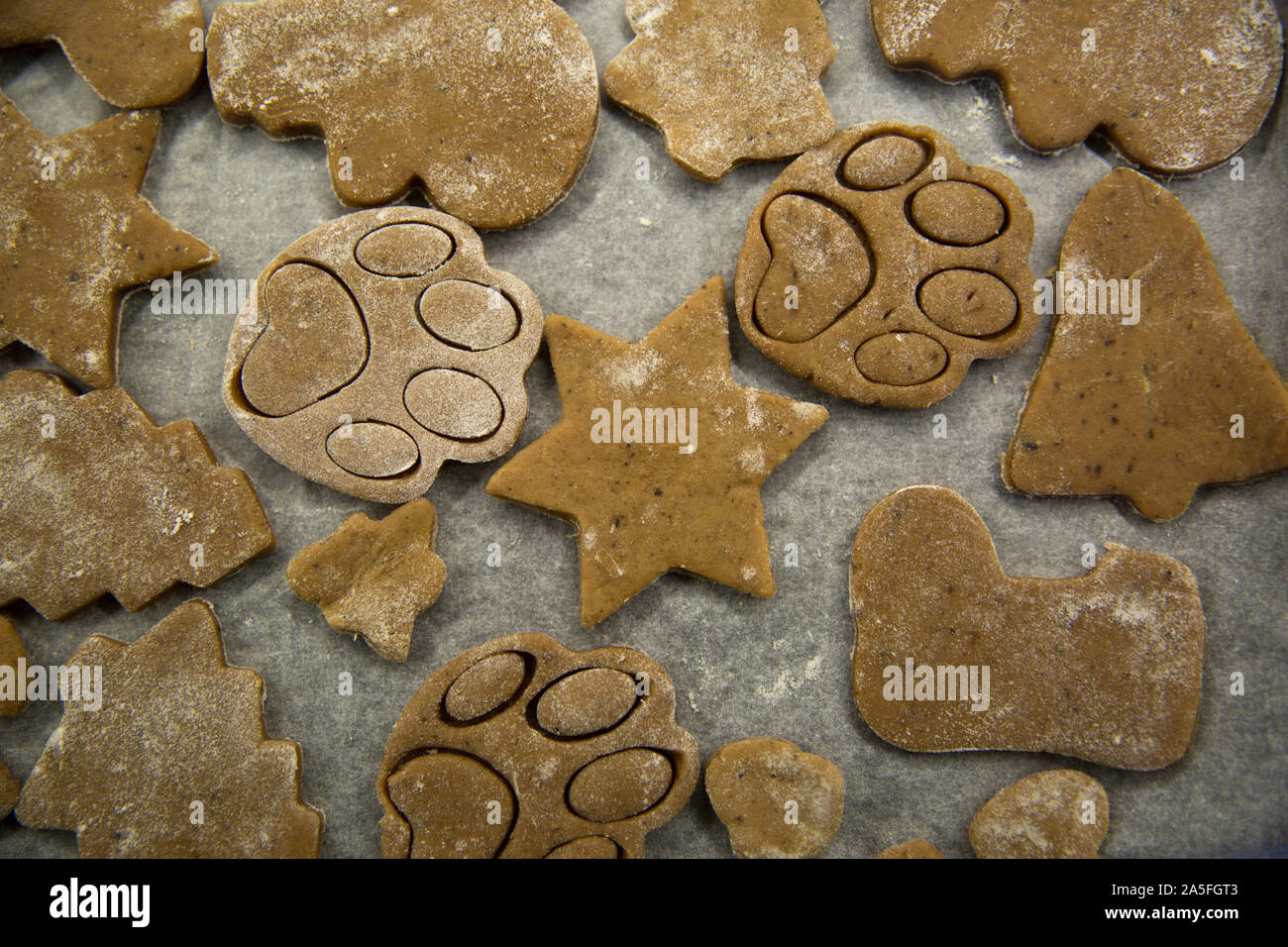 Tray of traditional Christmas ginger cookies, raw cookies in different shapes, bells, boots ...