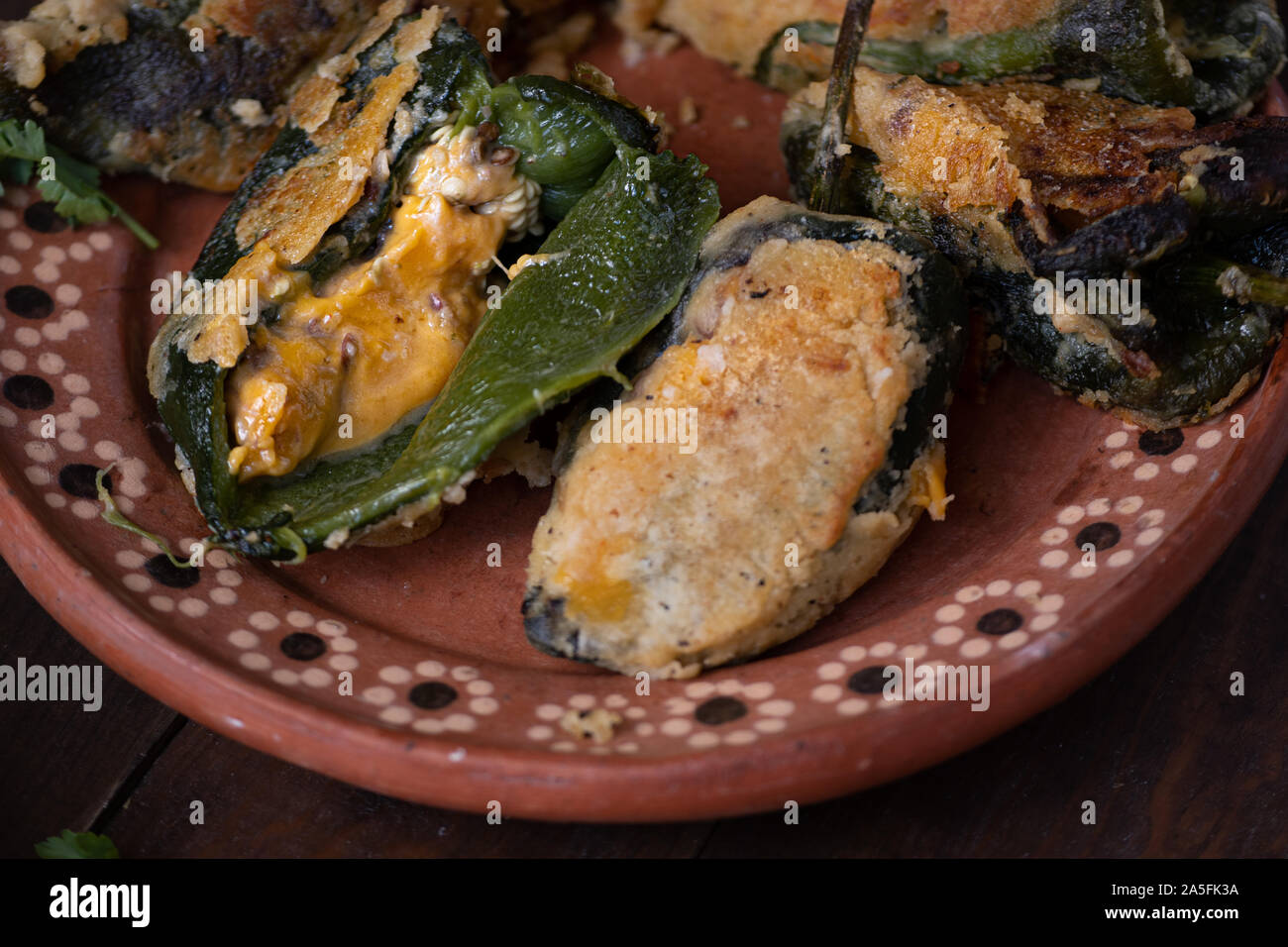 Chilles rellenos served in traditional Mexican dish Stock Photo - Alamy