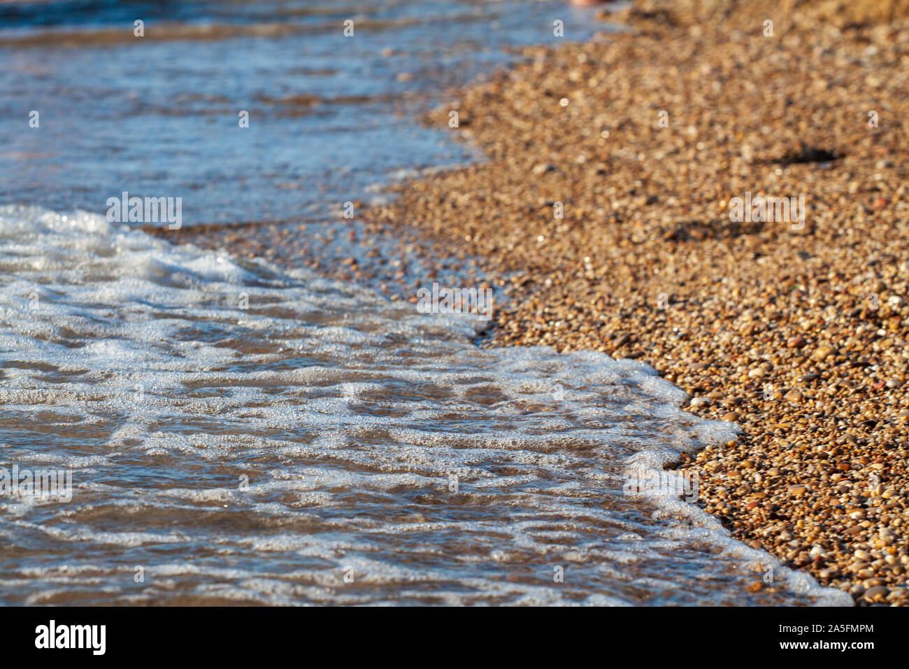 sea pebbles colored granite on the beach background stones. The shore ...