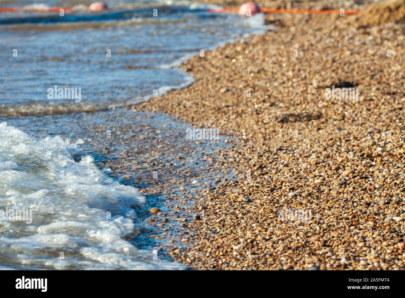sea pebbles colored granite on the beach background stones. The shore ...