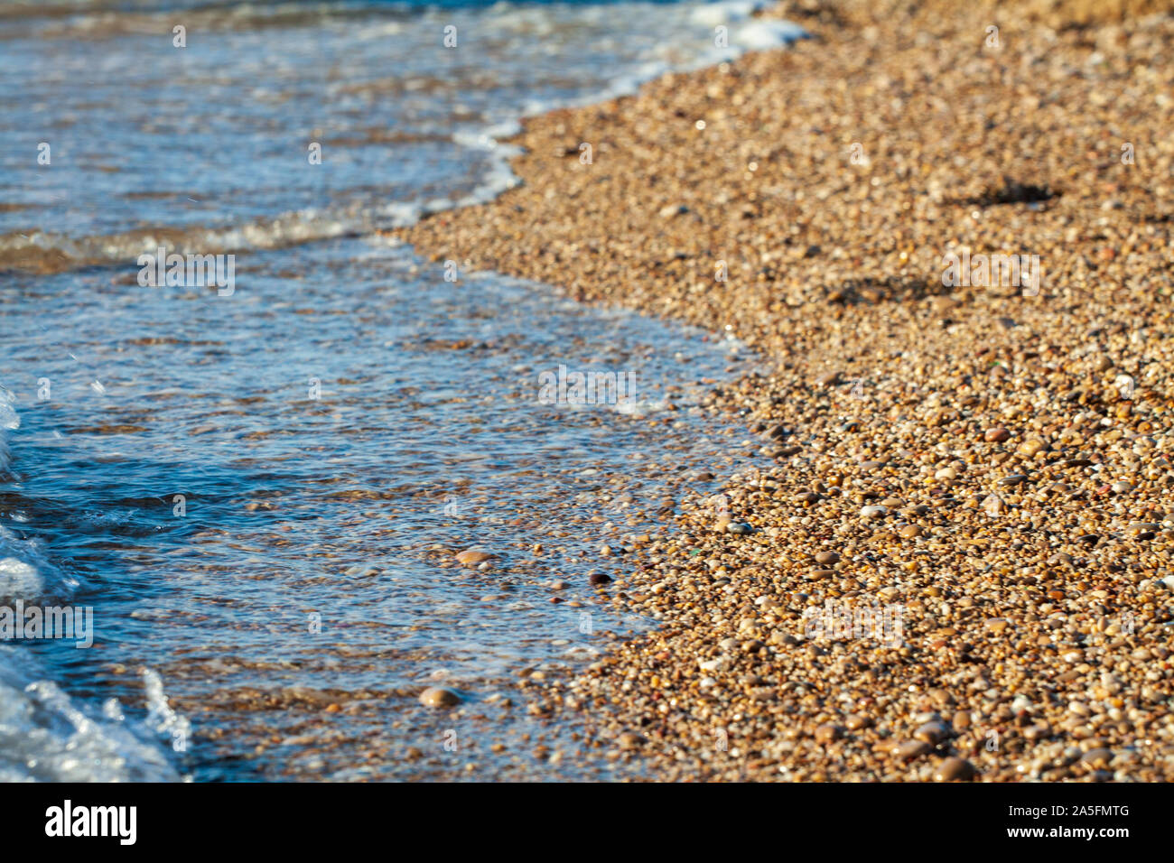 sea pebbles colored granite on the beach background stones. The shore ...