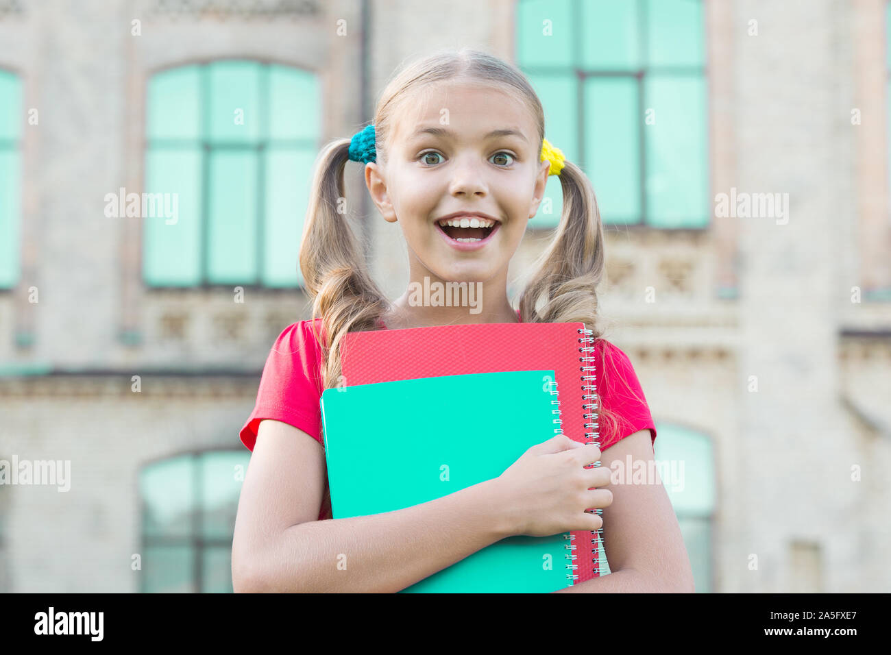 The books shes always dreamed of. Happy little girl hold books with ...
