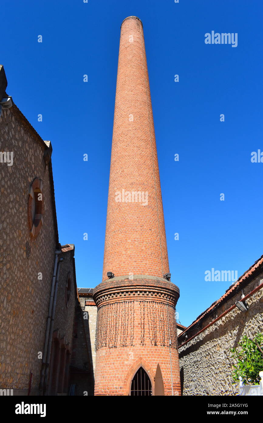 Tall old brick industrial chimney in south of France attached to a ...