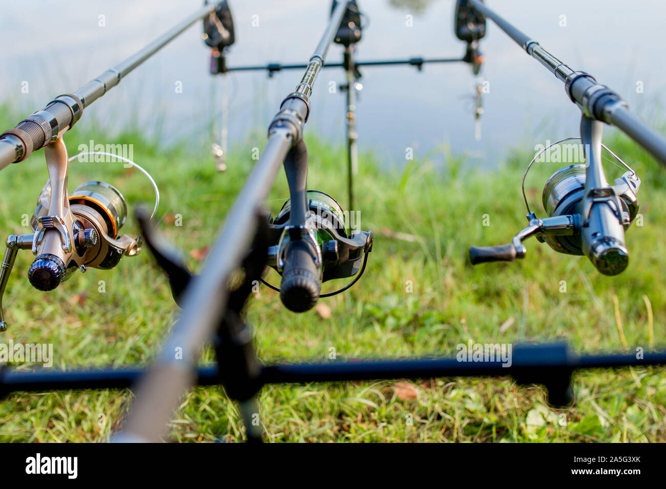Closeup of a reel fishing rod on a prop and water background Stock ...