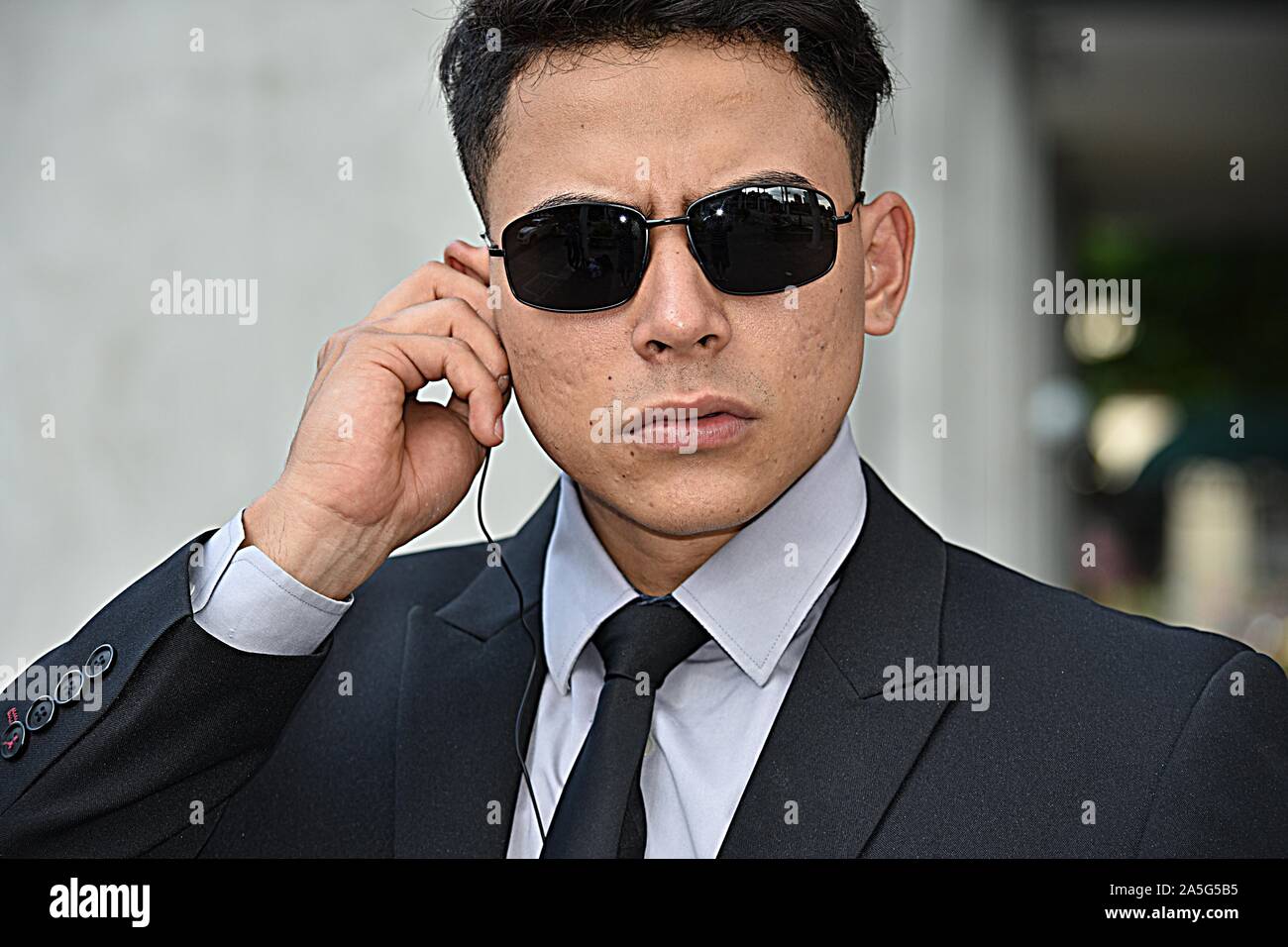Serious Young Colombian Security Guard Stock Photo - Alamy
