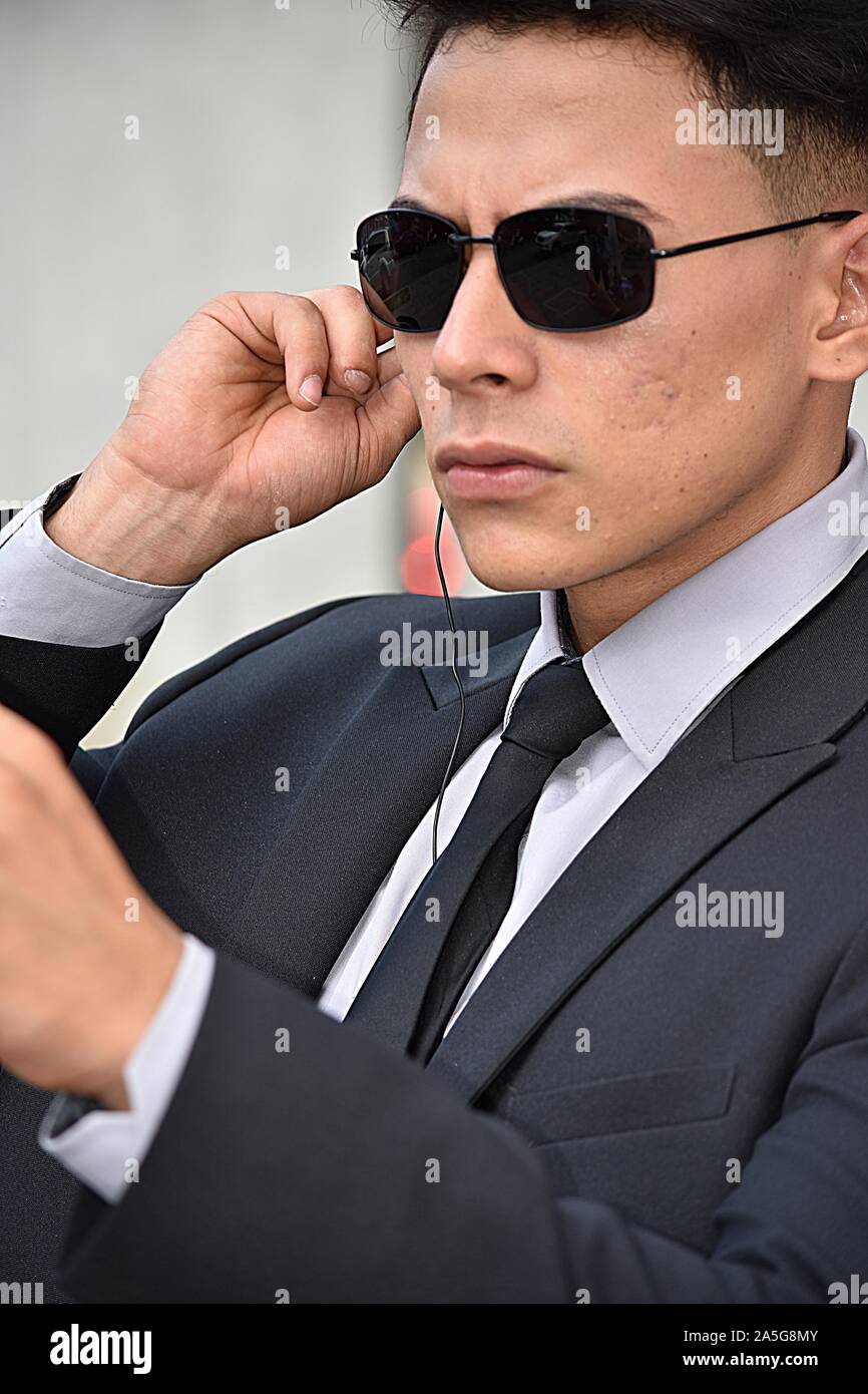 Serious Hispanic Security Guard Stock Photo - Alamy
