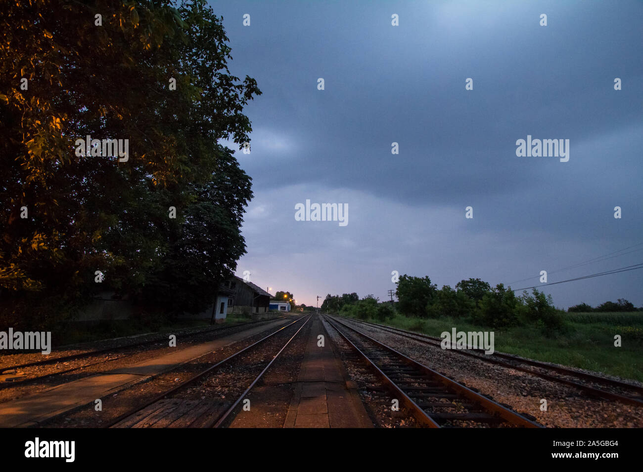 Railway tracks, rails and platforms in a rural train station in ...