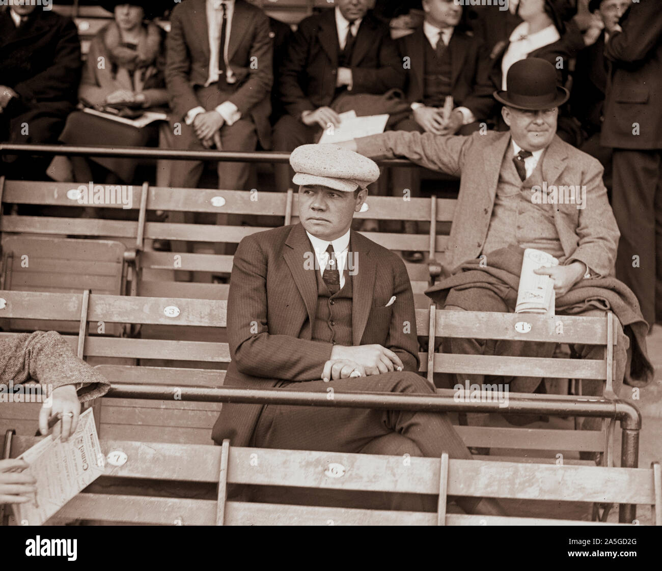 Babe Ruth in street clothes sits alone in baseball stadium stands Stock ...