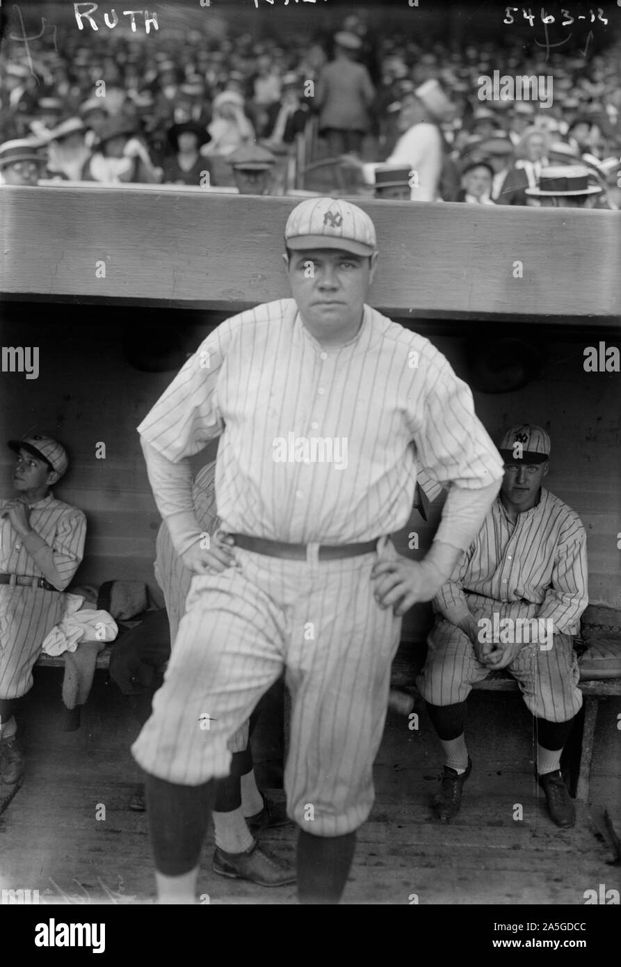 Babe Ruth in baseball uniform standing in dugout Stock Photo - Alamy