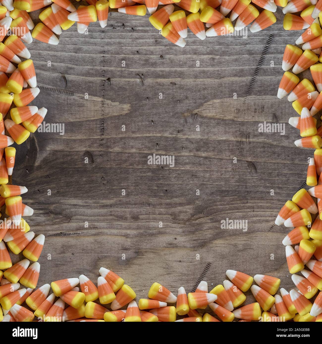 Candy corn frame over a wooden surface great for background or writing ...