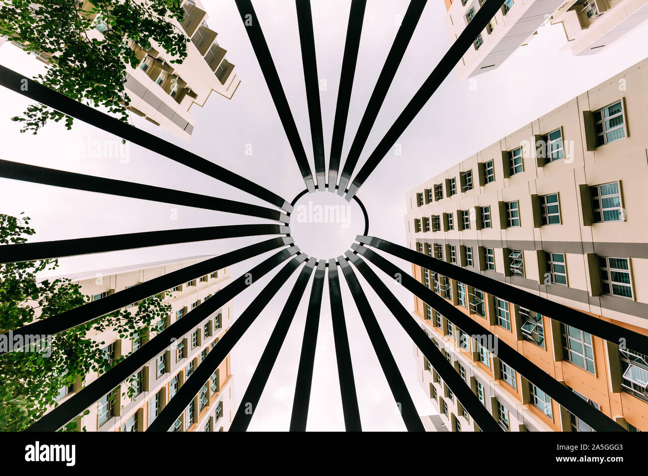 looking up view of residential tower building from landscape pavilion ...