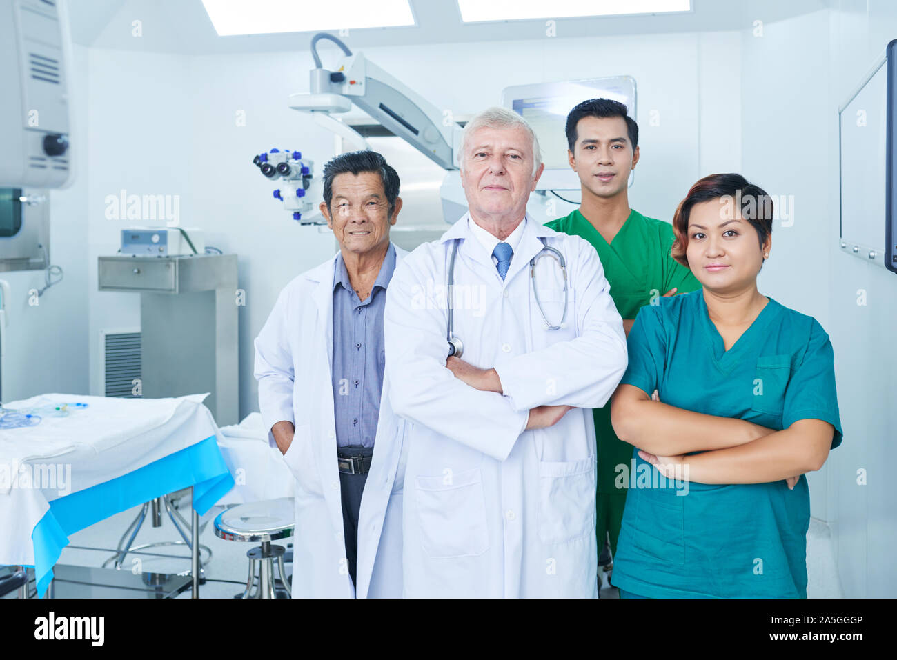 Team of confident multi-ethnic medical workers in uniform standing in ...