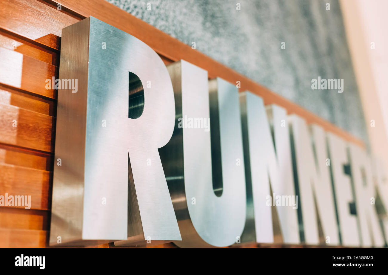 silver color metal runner sign board detail Stock Photo - Alamy