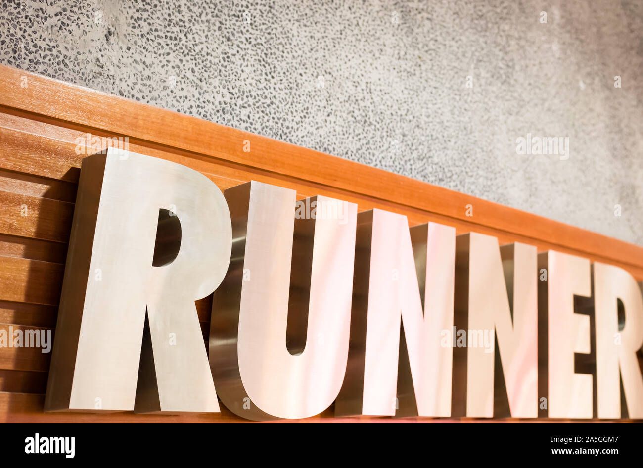 silver color metal runner sign board detail Stock Photo - Alamy