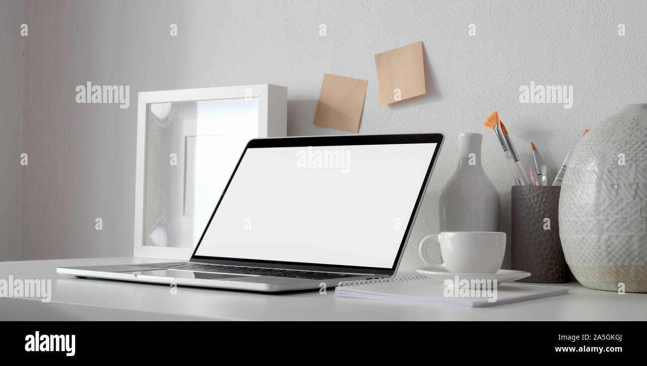 Minimal workspace with open blank screen laptop computer and mock up ...