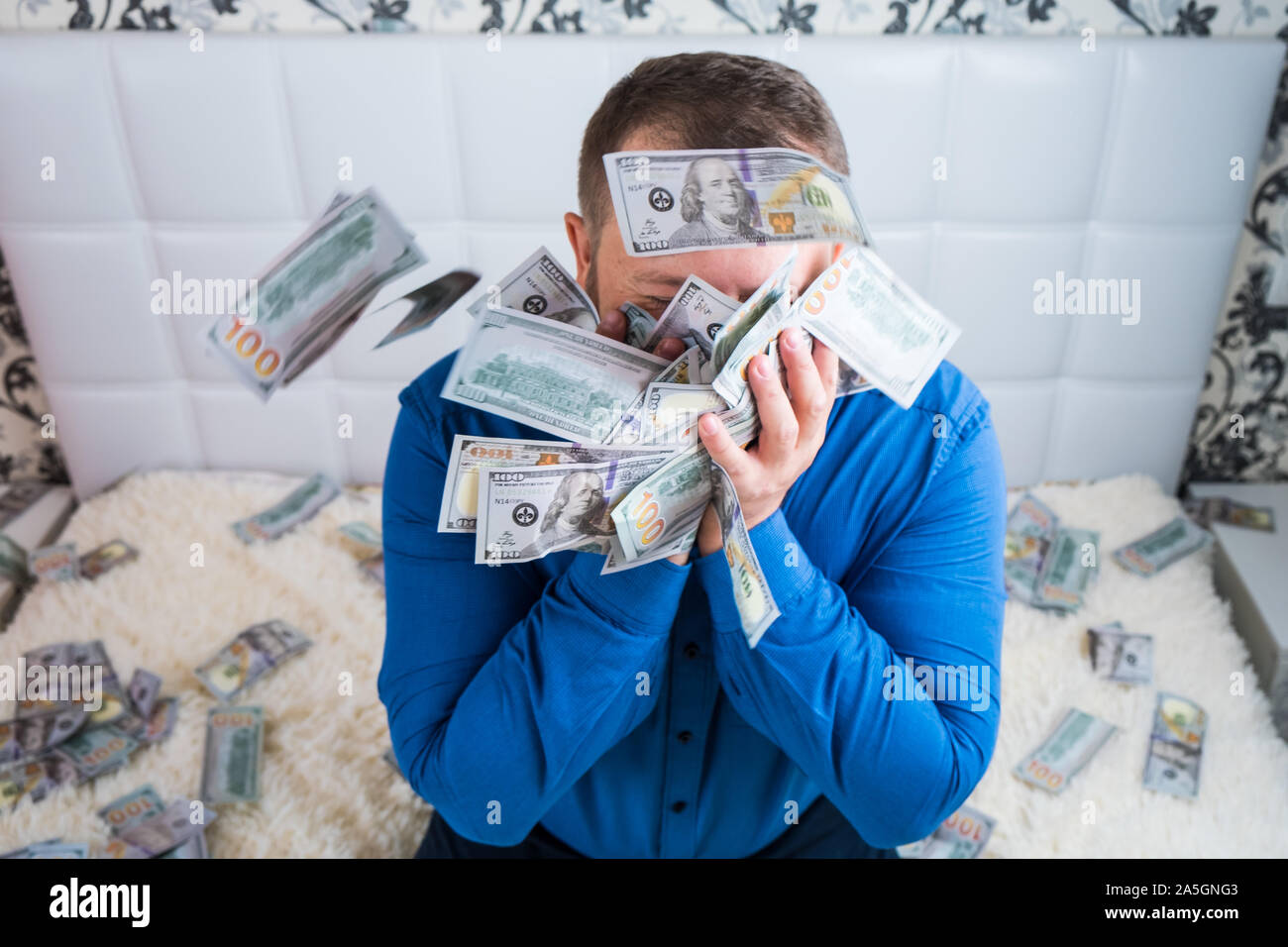 male holds in his hands a lot of money. and kisses them. A man enjoys a ...