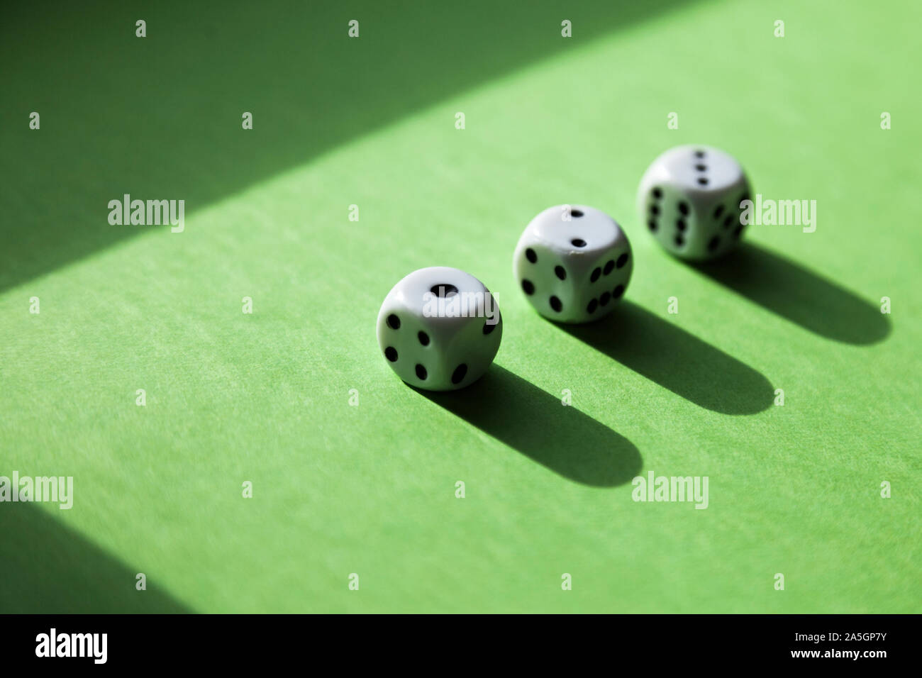three dice in a row with the numbers one to three on a green background ...