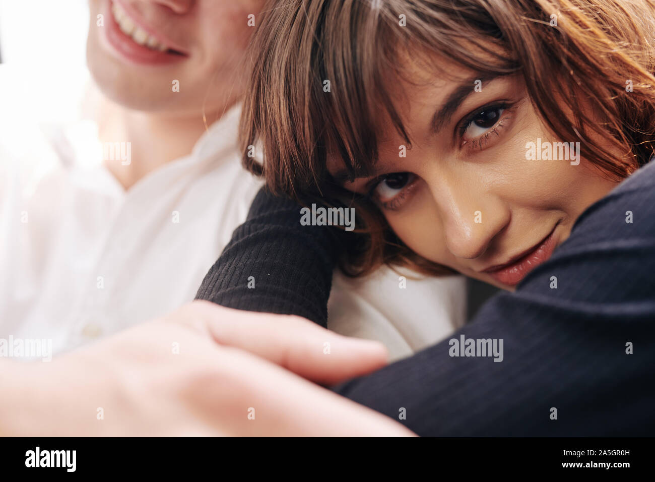 Two females sitting down hugging hi-res stock photography and images ...