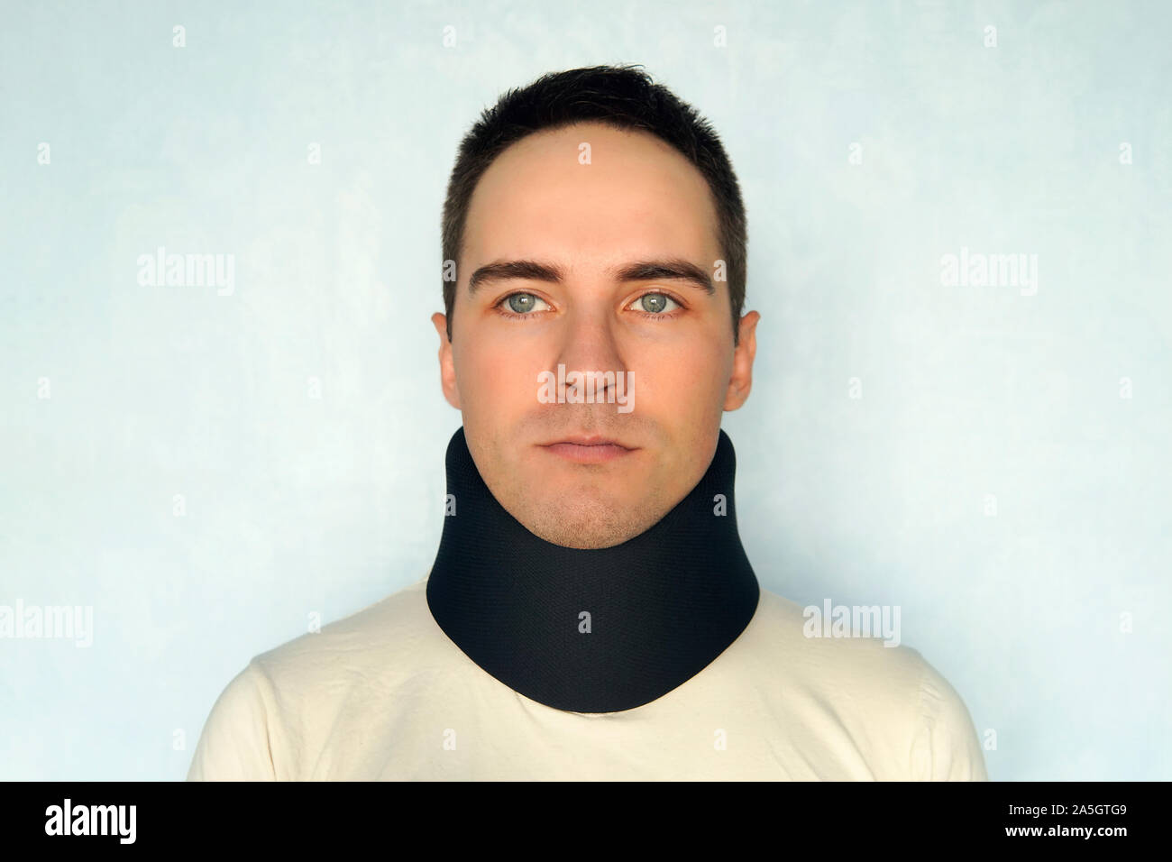 Medical cervical collar. a sick man with a black collar to fix a neck ...