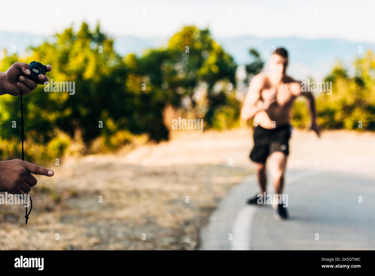 Running stopwatch in the hand measuring time for running sprinter Stock ...