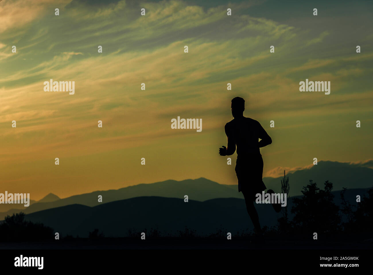 Male runner silhouette workout. Man running into sunset, colorful ...