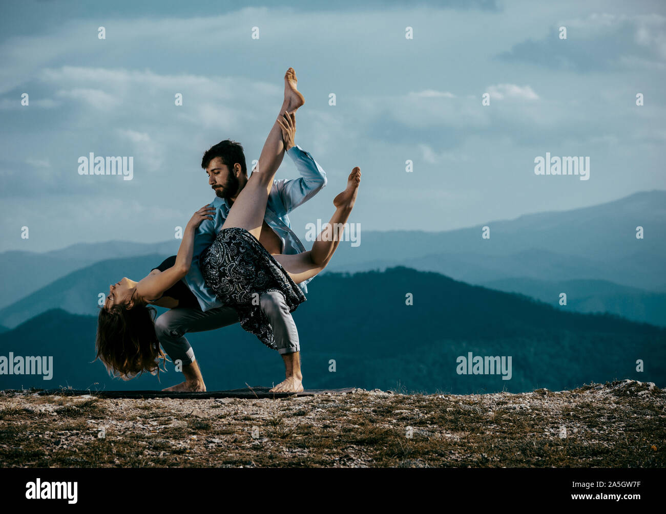 Two modern dancers couple teen woman and man dancing on peak Urban ...