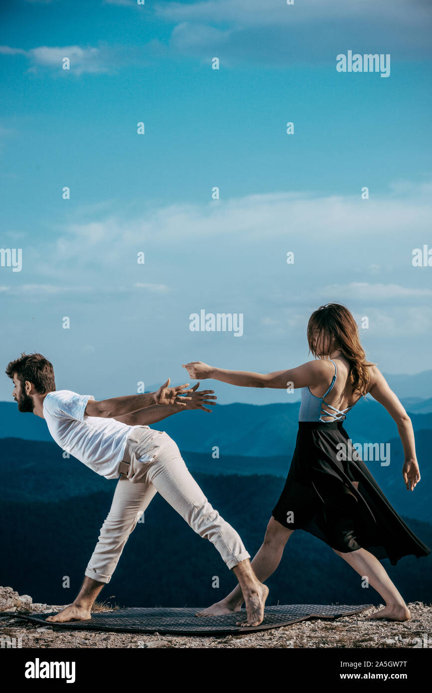 Skillful hip-hop dancers in movement. Young couple of modern dance ...