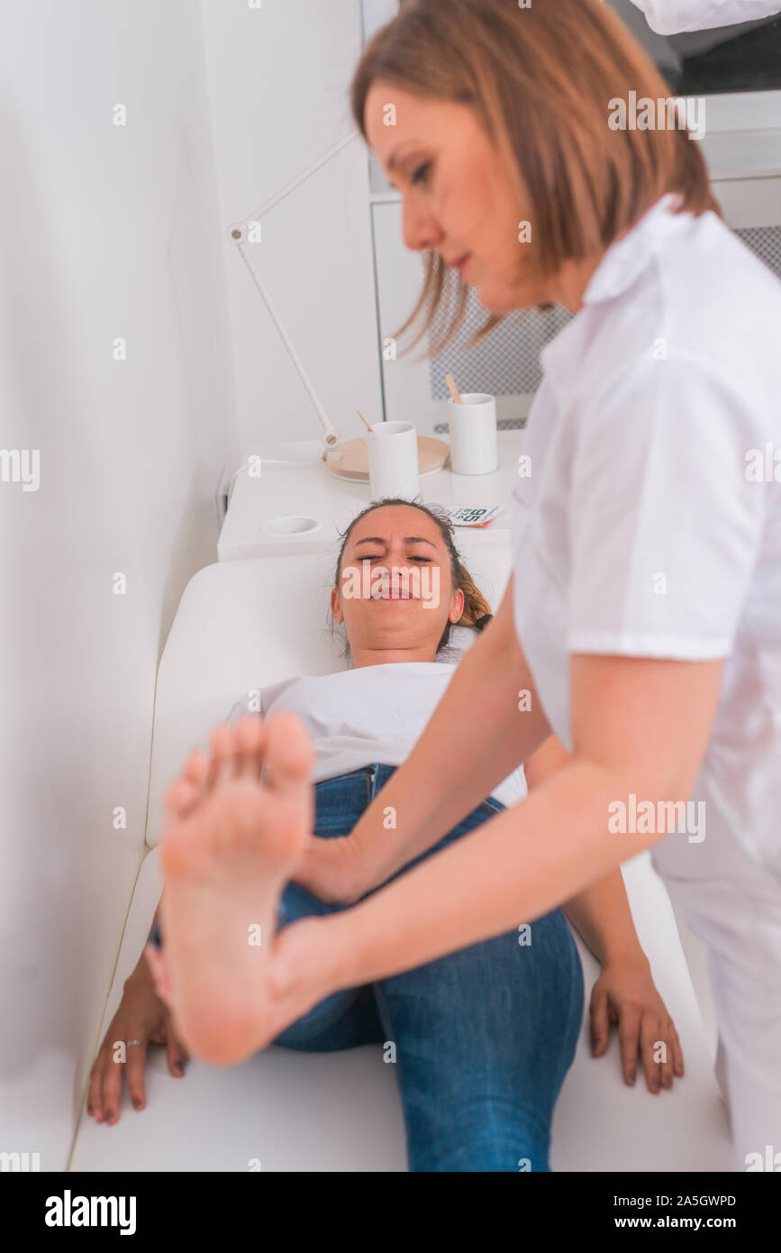 Physiotherapist ( doctor ) examining the neurological system and muscle ...