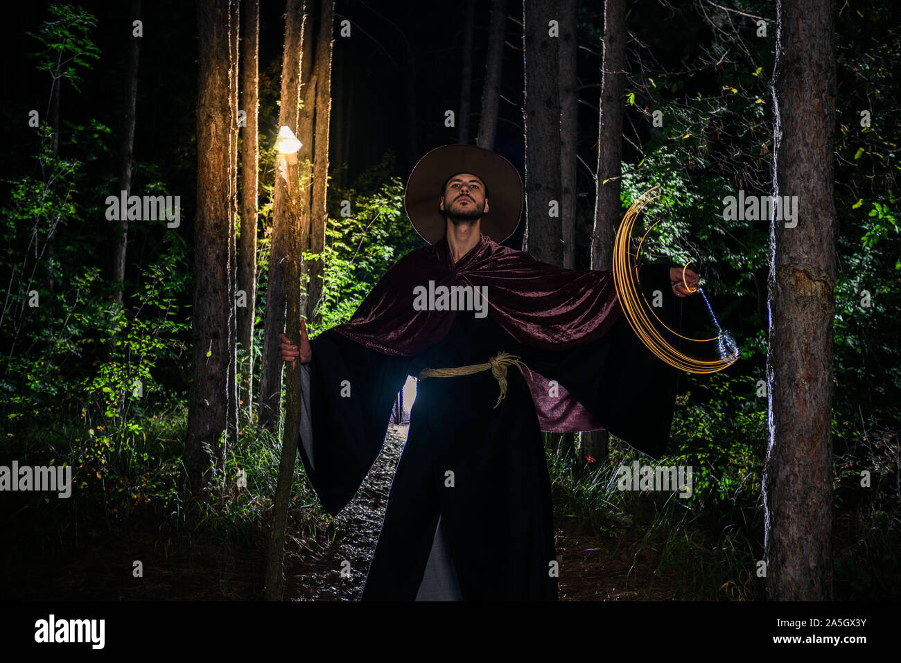 Guy wearing fantasy magician halloween costume and performing magic ...