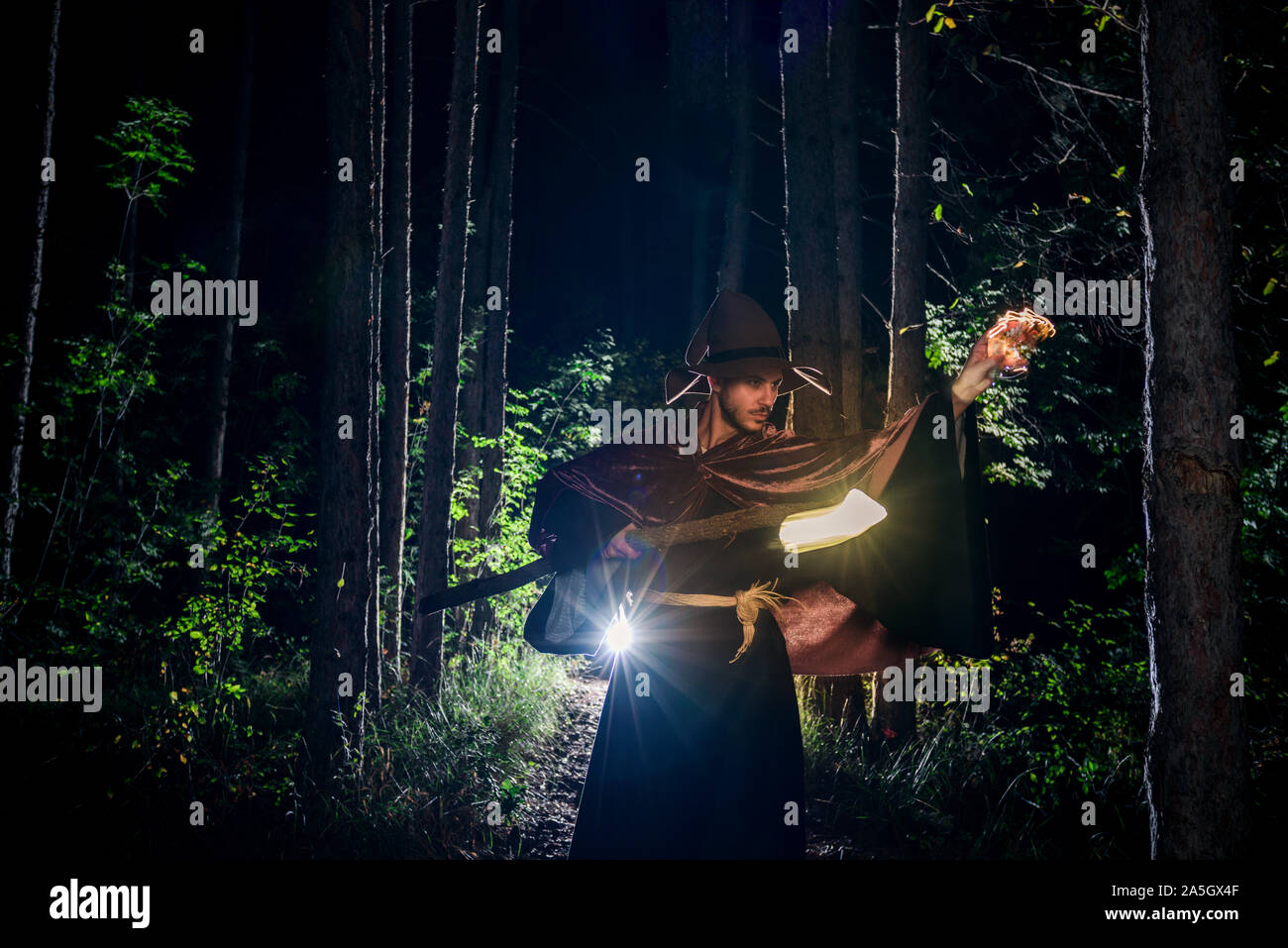 Wizard looking at something in the forest and casting spells with his ...