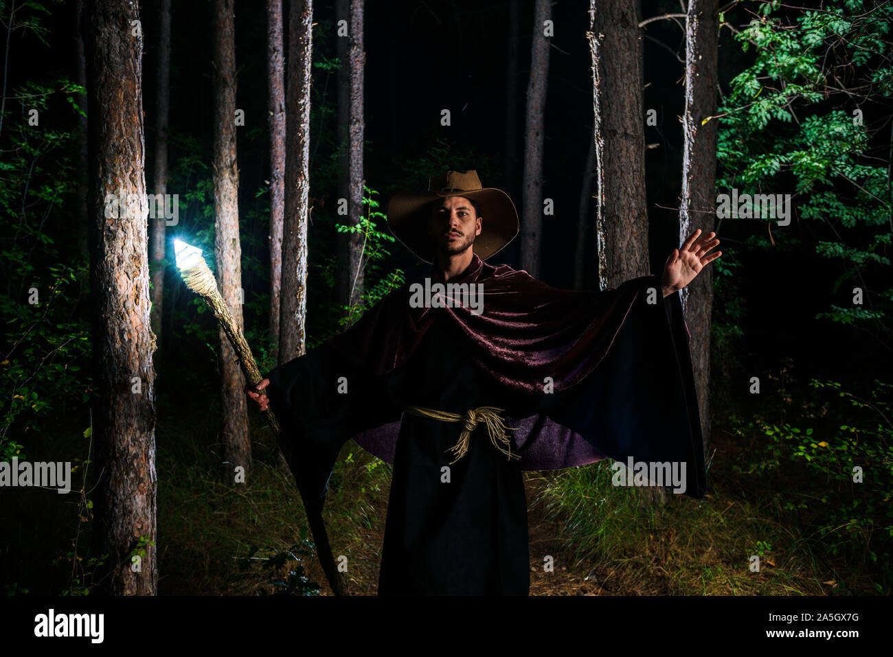 Portrait of young mysterious wizard having fun into the woods Stock ...