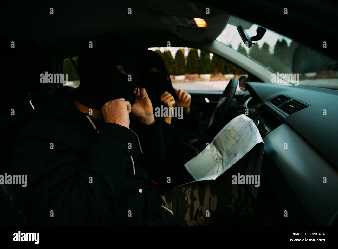 bank robbers putting their mask on prepared to do their next robbery ...