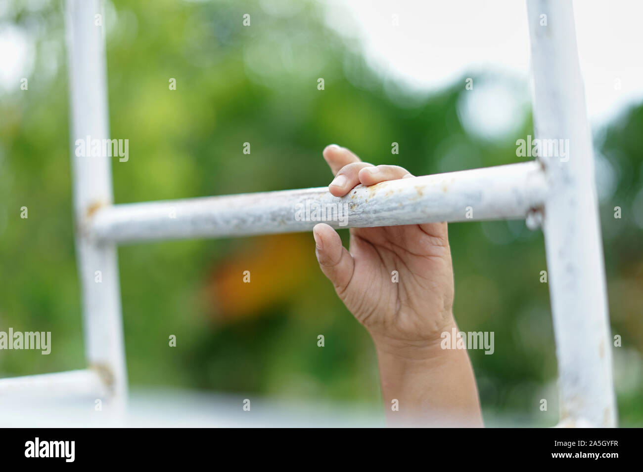 Children's hands holding on to Bar Stock Photo - Alamy