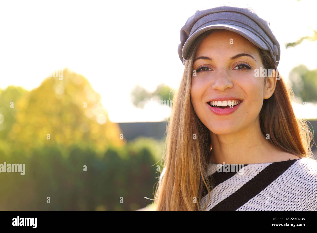 Close up of young fashion woman with hat in park on autumn season ...