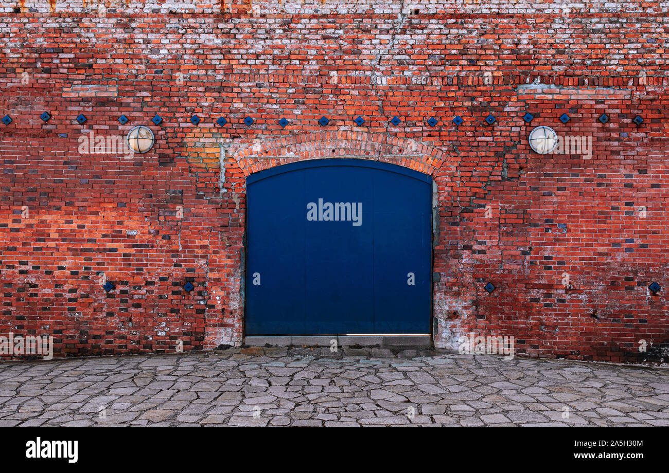 Blue iron gate with red brick wall old rustic industrial loft retro ...