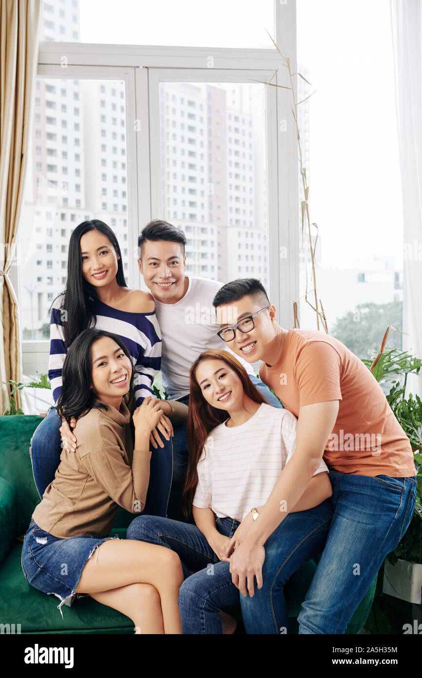 Happy group of friends posing together and looking at camera Stock ...