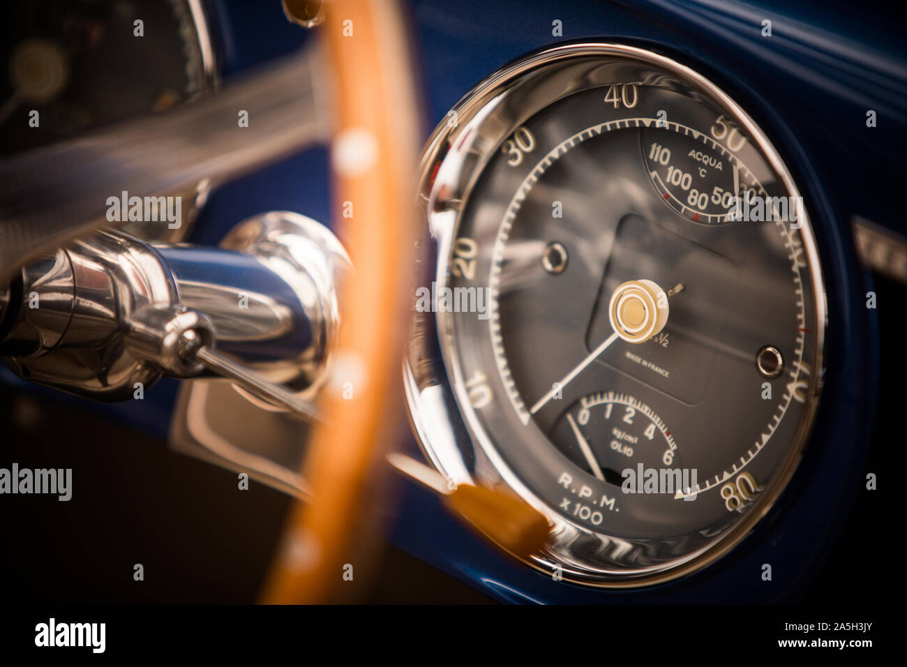 Color close up shot of a blue speedometer on a vintage car's dashboard ...
