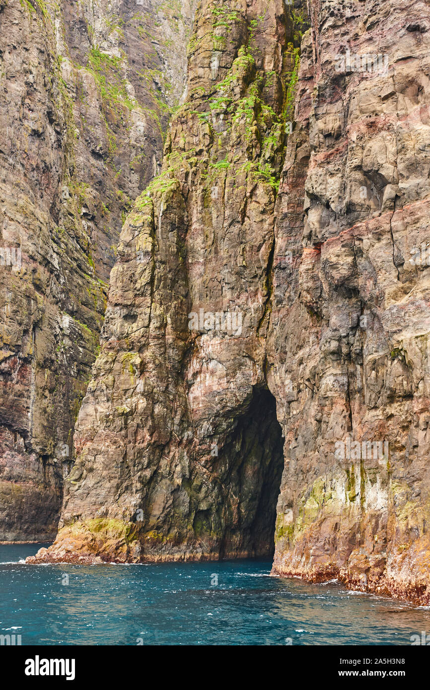 Stunning stone cliffs and caves on atlantic ocean in Faroe islands ...