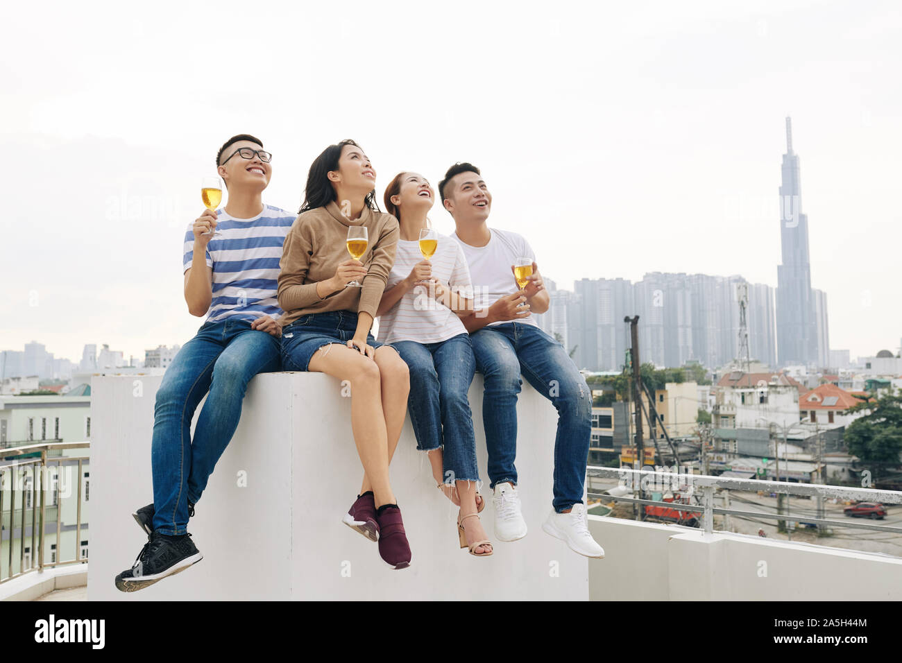 Men women sitting on roof hi-res stock photography and images - Alamy