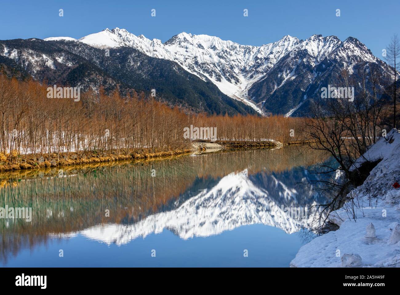 Snow-covered mountains at a lake, Japanese Alps reflected in Taisho ...