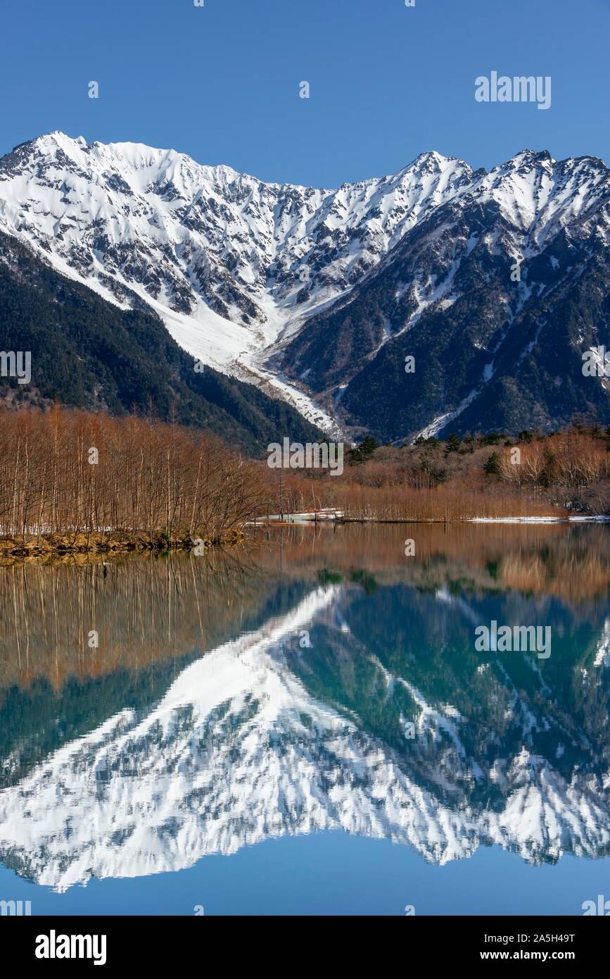 Snow-covered mountains at a lake, Japanese Alps reflected in Taisho ...