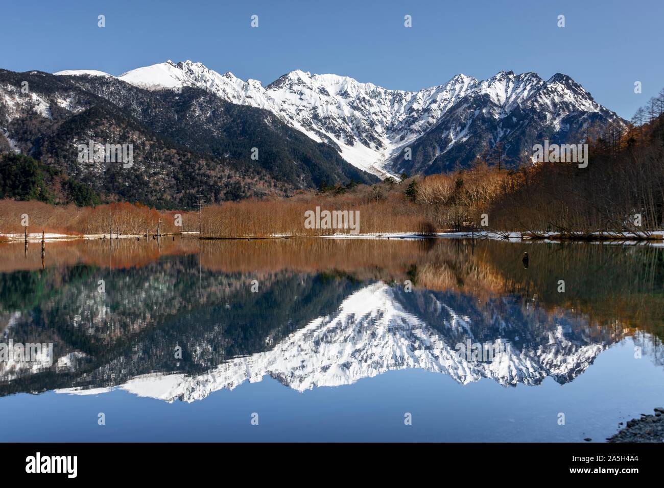 Snow-covered mountains at a lake, Japanese Alps reflected in Taisho ...