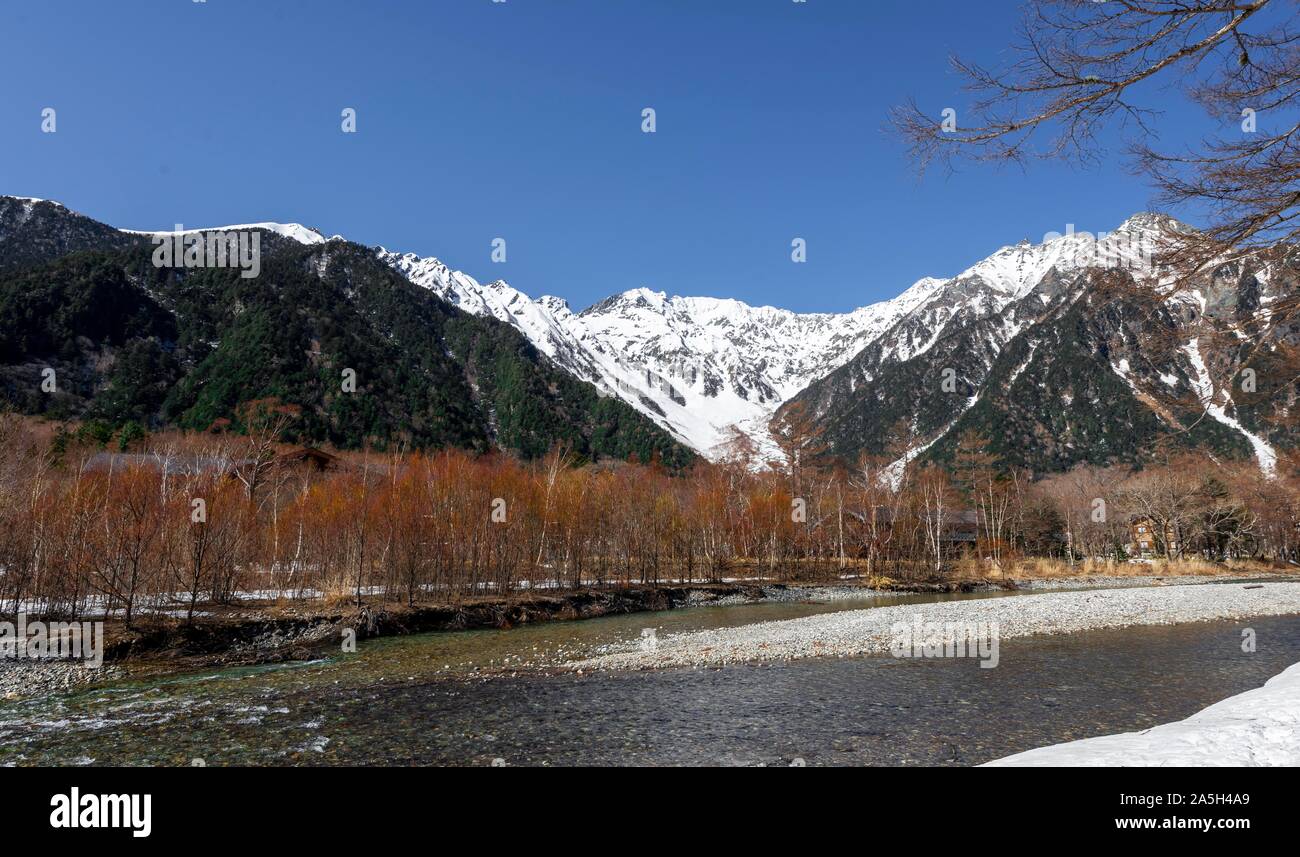 Snow-covered mountains on a river, Japanese Alps and Azusa river, snow ...