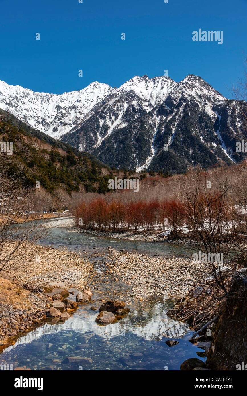 Snow-covered mountains on a river, Japanese Alps and Azusa river, snow ...