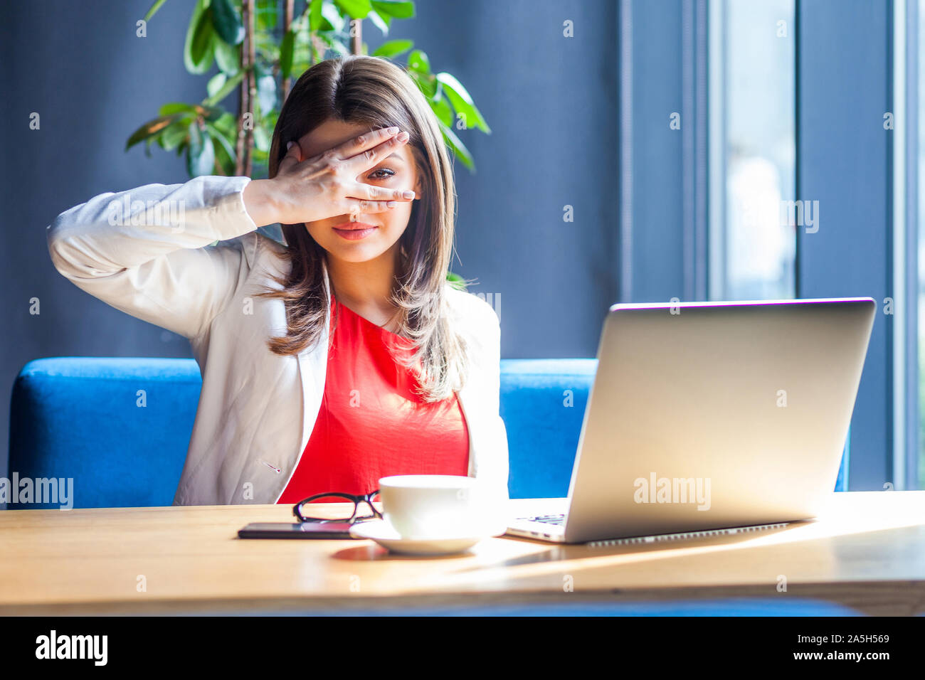 Portrait of cunning beautiful stylish brunette young woman sitting and ...