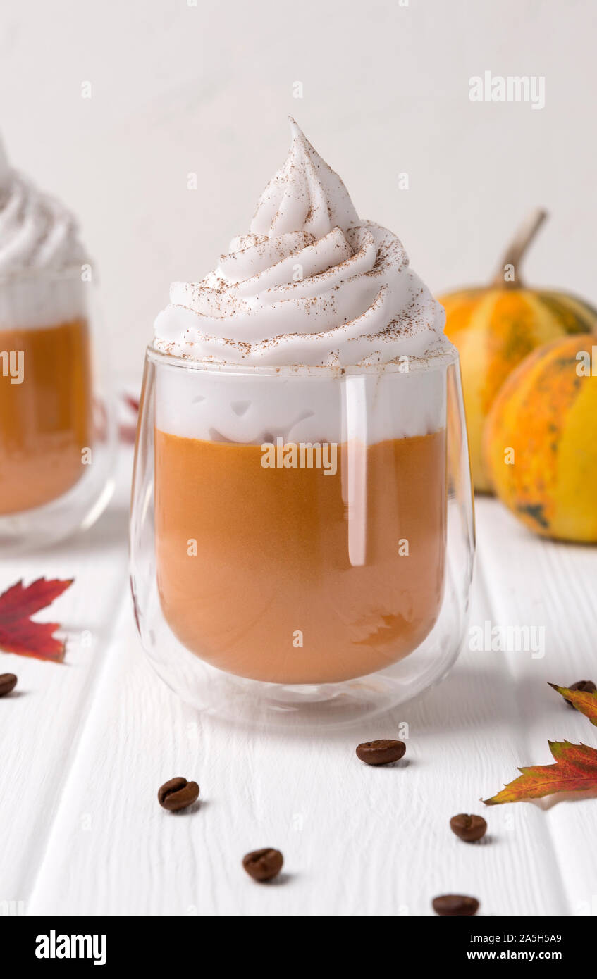Cocktail with whipped cream on top on white wooden background with copy ...