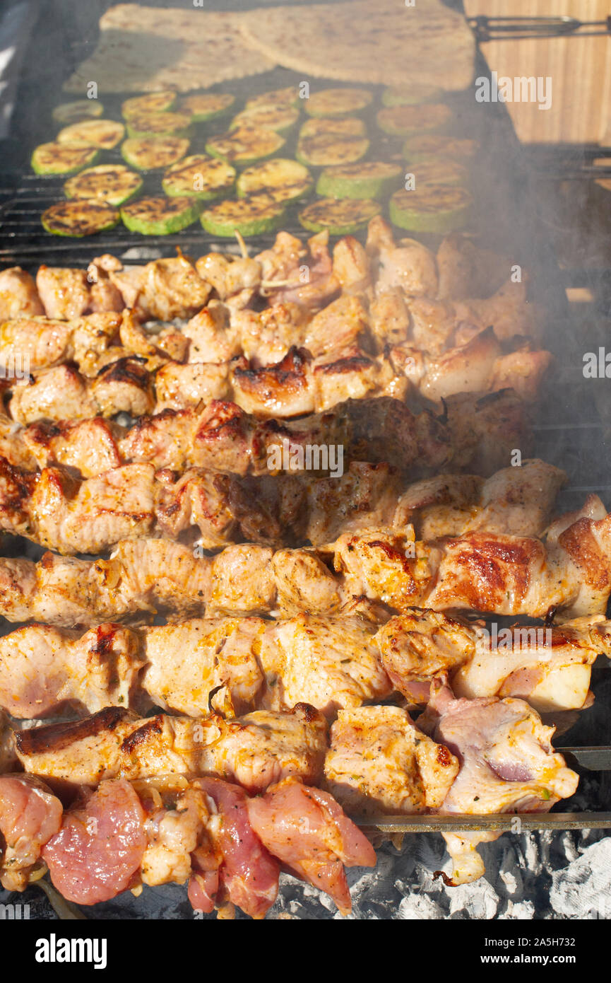 Grilled kebab cooking on metal skewer. Roasted meat cooked at barbecue ...